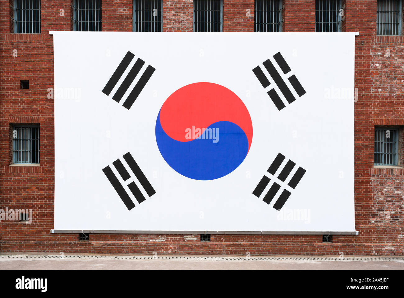 Giant South Korean flag on the red bricks wall of Seodaemun prison hall ...