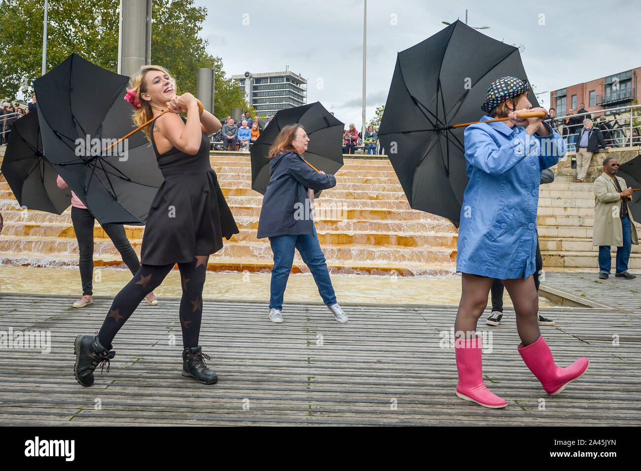 People take part during a Singin' in the Rain flash mob outside the the ...