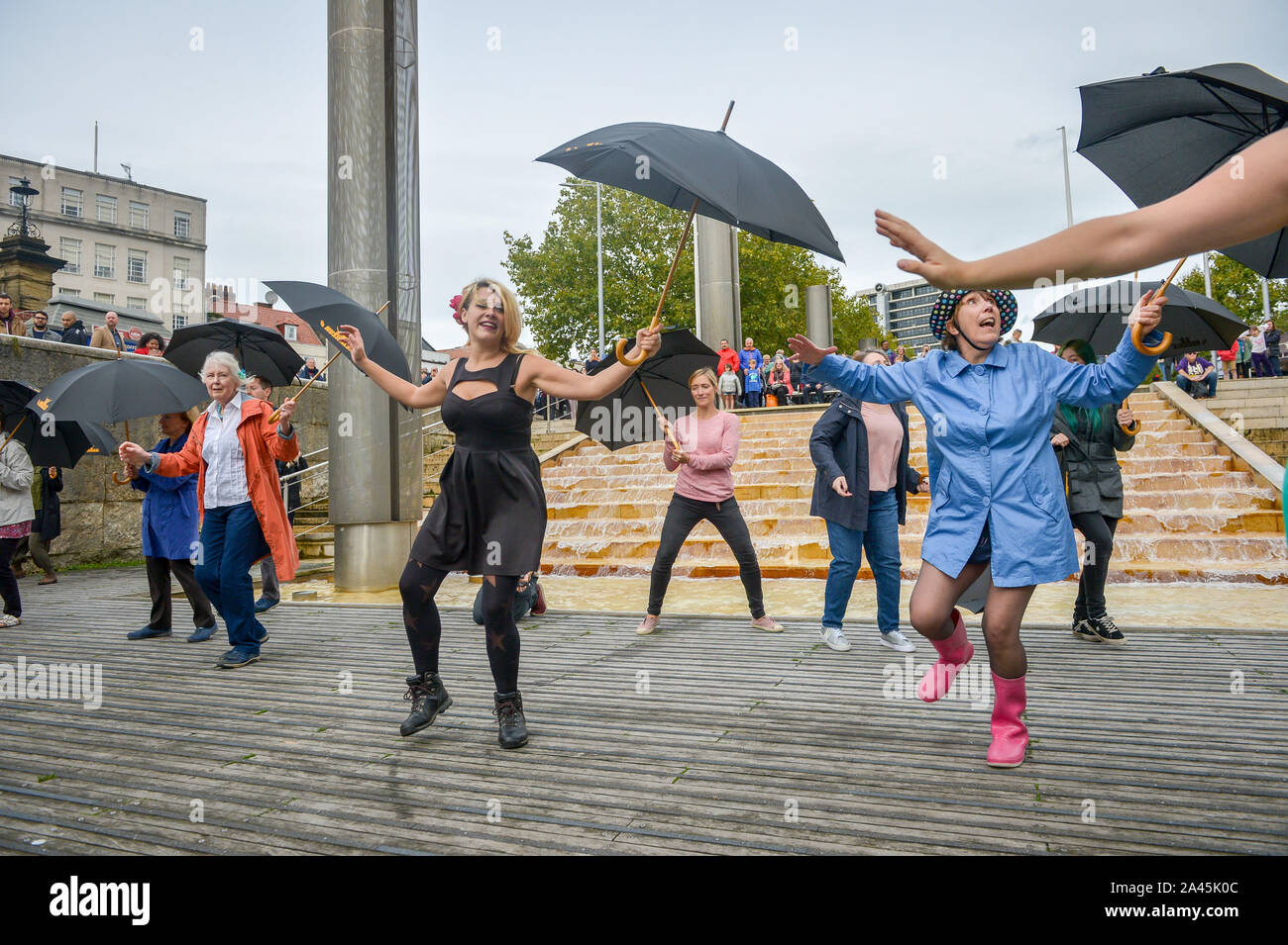 People take part during a Singin' in the Rain flash mob outside the the ...