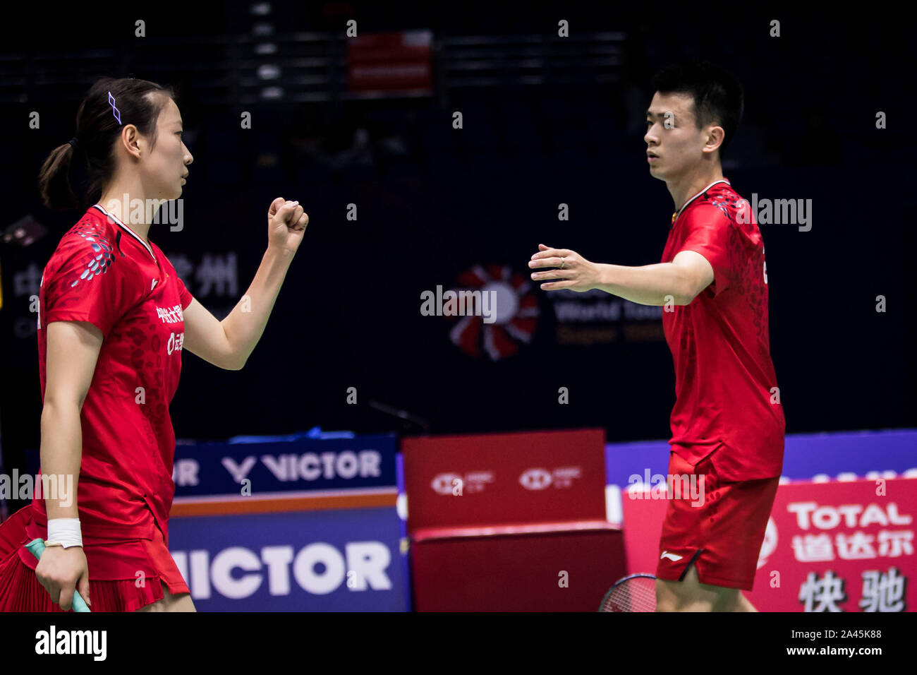 Chinese professional badminton players Zheng Siwei and Huang Yaqiong compete against Japanese ...