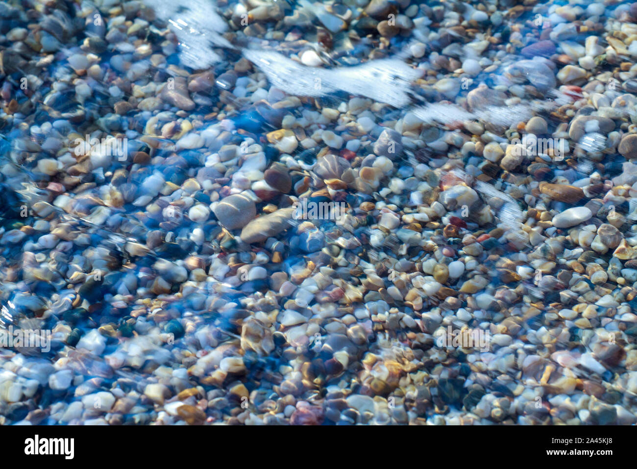 sea pebbles colored granite on the beach background stones. The shore ...