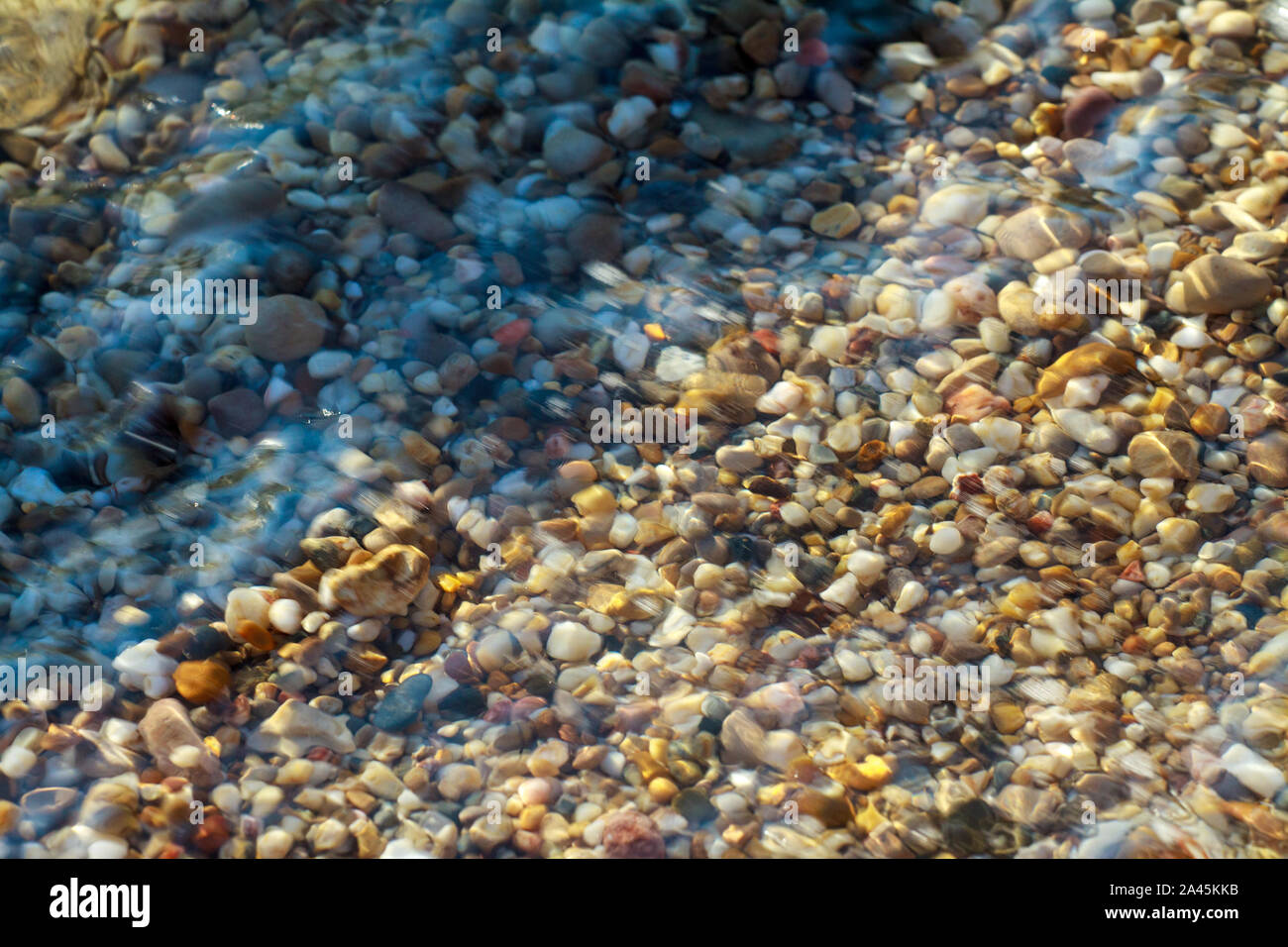 sea pebbles colored granite on the beach background stones. The shore ...