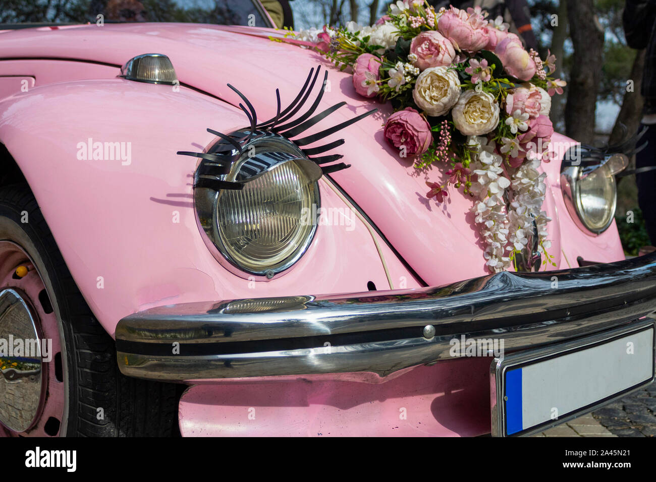 Pink classic convertible car and flowers on hood Stock Photo - Alamy