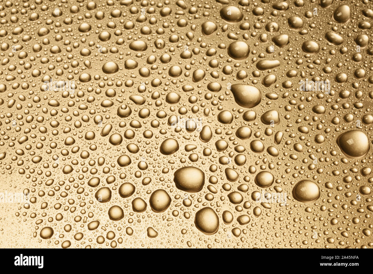 Close-up of water drops on surface, gold background Stock Photo - Alamy