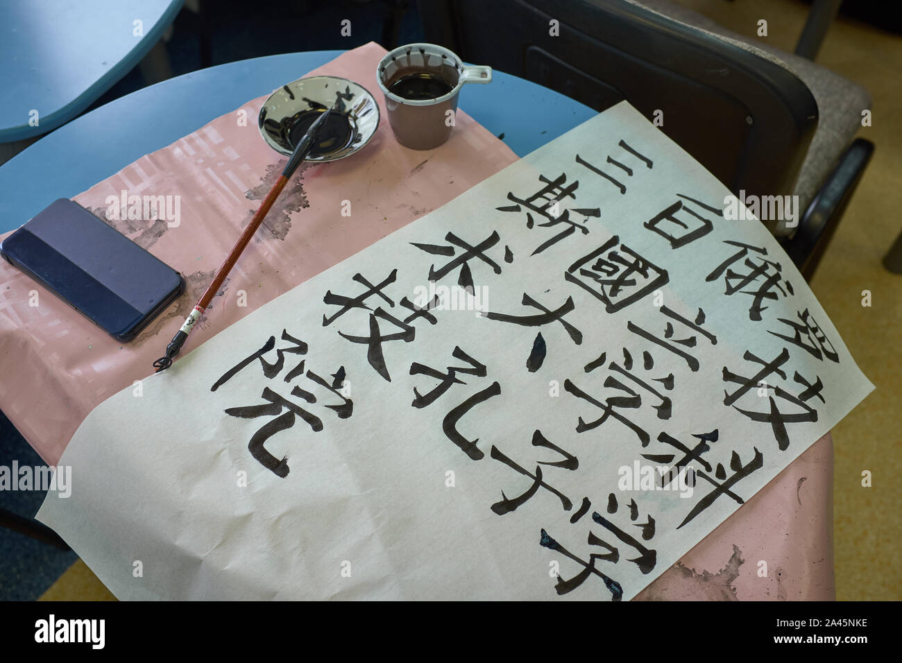 Chinese ink brush and ink drops in work. After writing some chinese ...