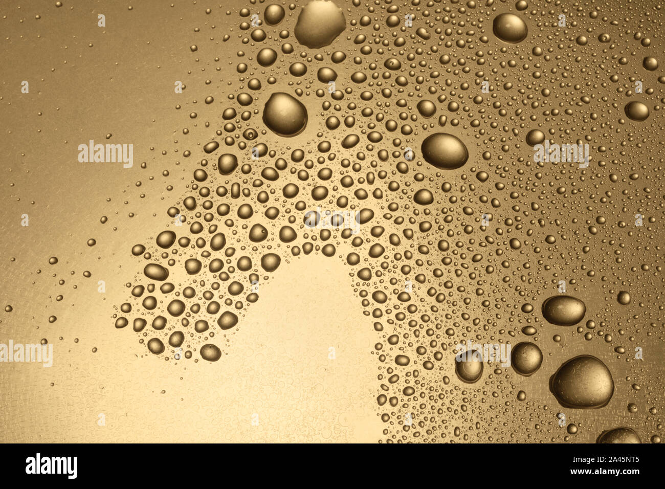 Close-up of water drops on surface, gold background Stock Photo - Alamy