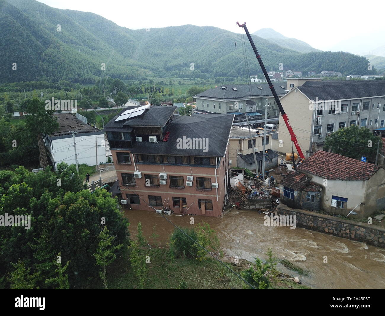 A house tilts to the river due to heavy rainstorm caused by Typhoon ...