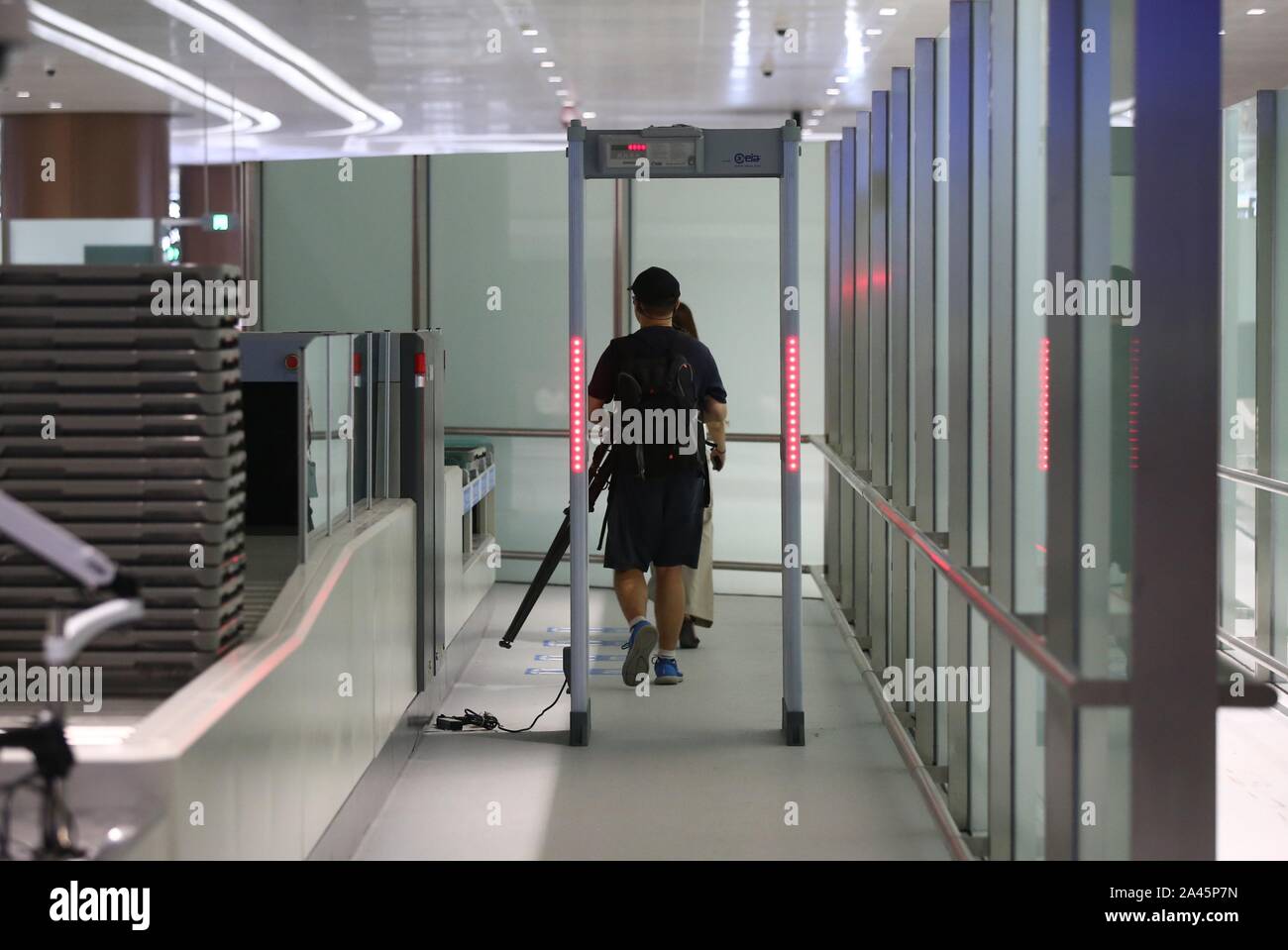 People walk past the security check in the Beijing Daxing International ...