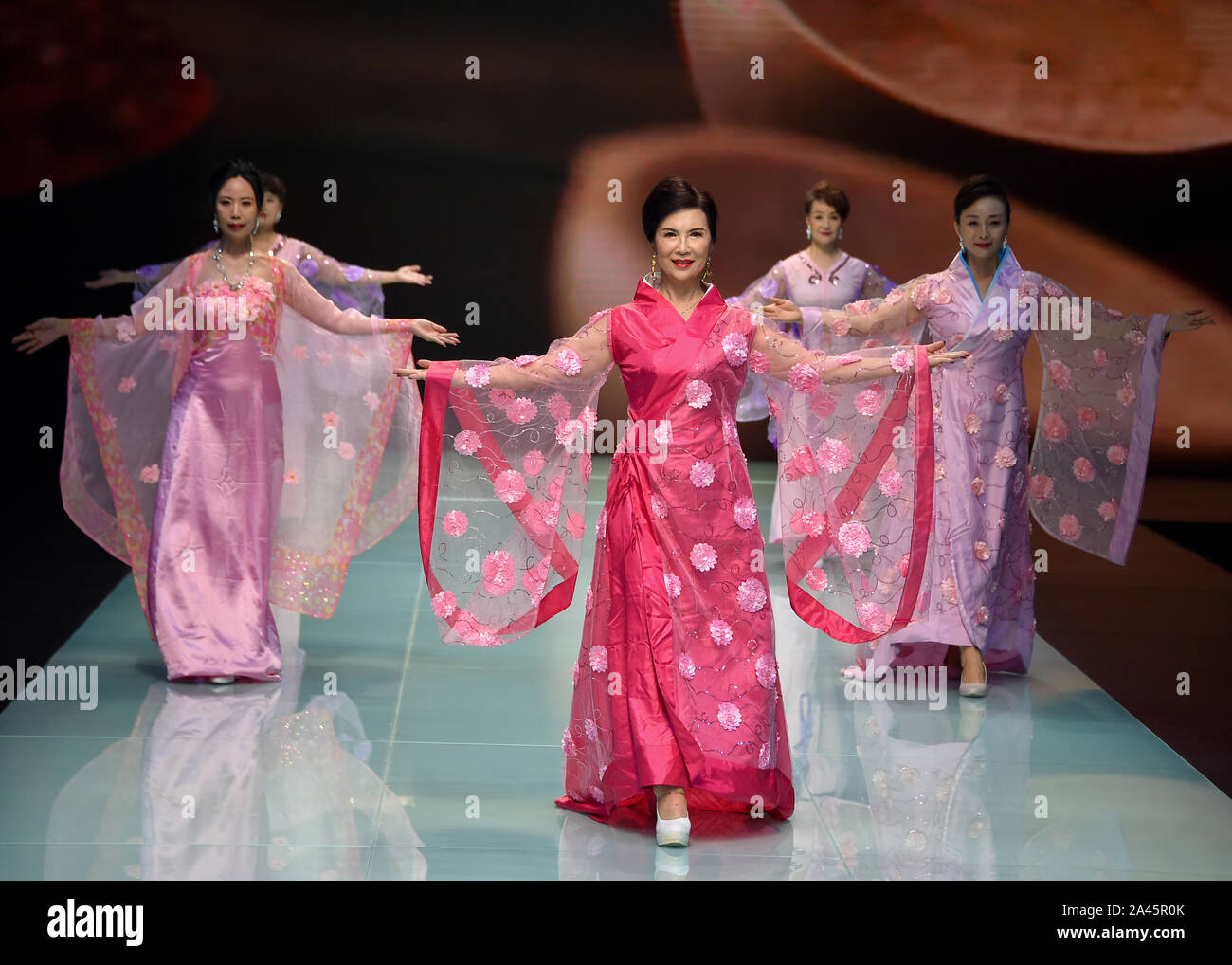 Elder models wearing traditional Chinese outfit designed by Chen Fumei ...