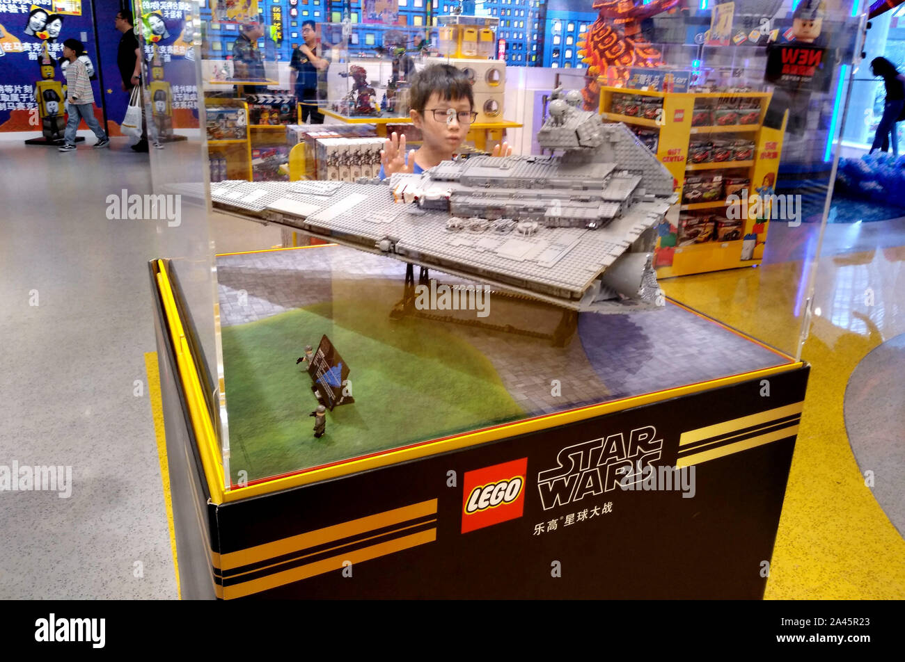 Consumers stroll and observe new LEGO models exhibited as the first ...