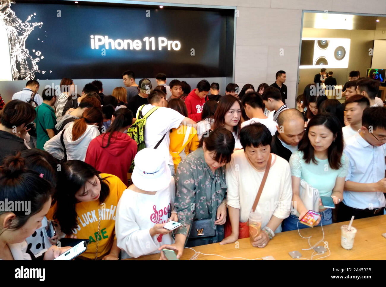 The Apple retail store is crowded with fans waiting to experience the ...