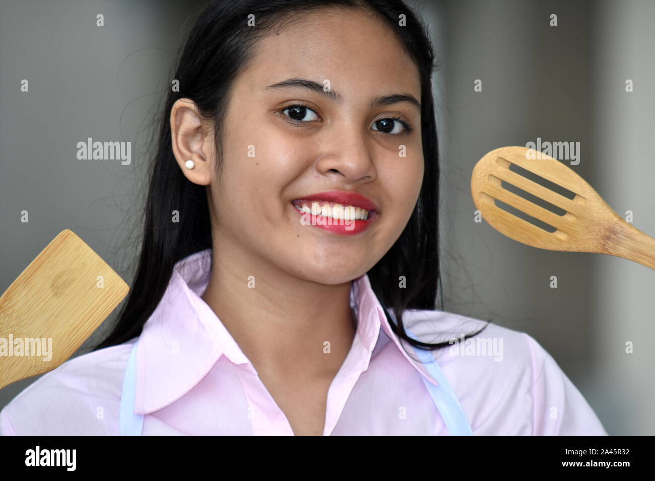 Female Teen With Cooking Utensils Stock Photo - Alamy