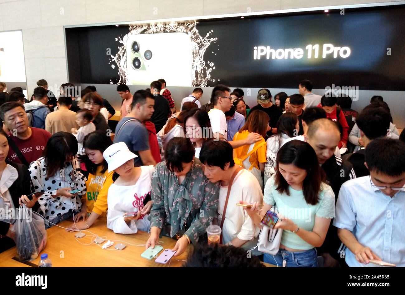 The Apple retail store is crowded with fans waiting to experience the ...