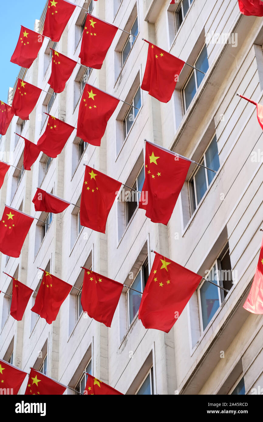 Chinese national flags flutter on the windows at the campus of Liaoning ...