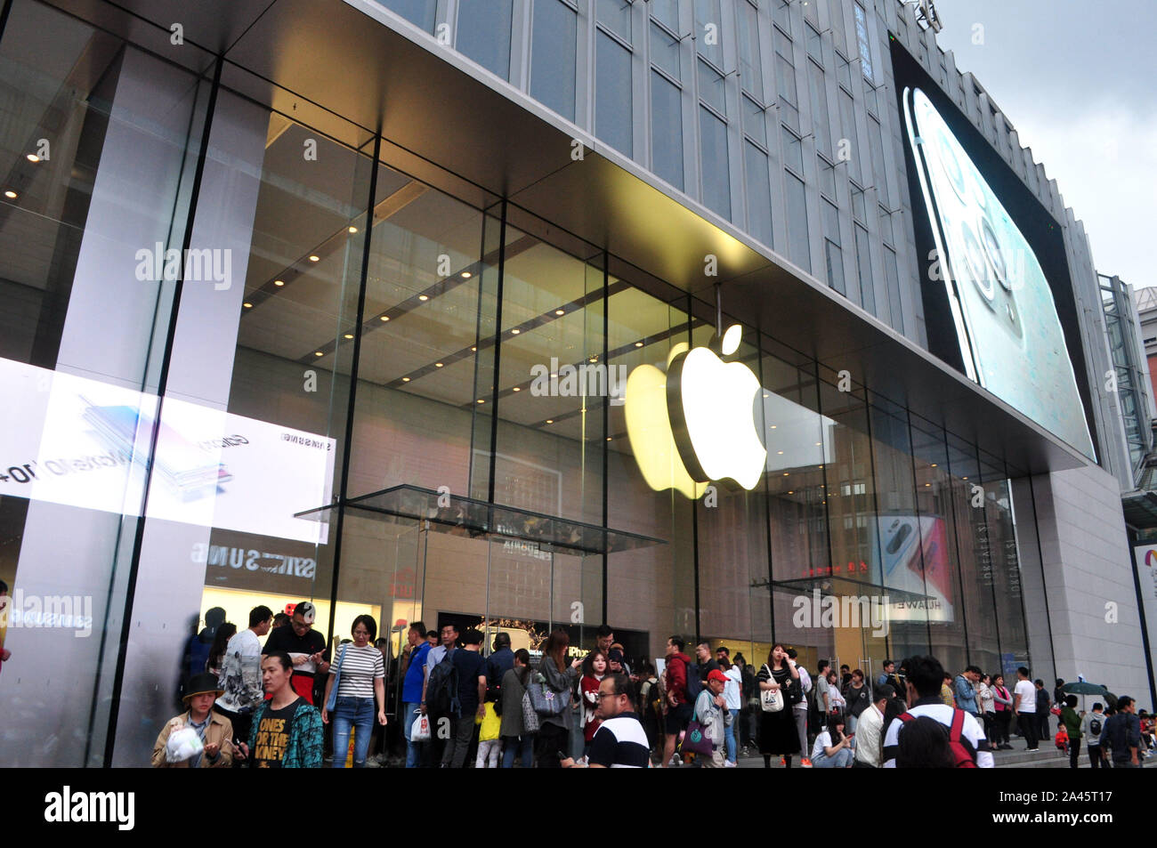 The Apple retail store is crowded with fans waiting to experience the ...