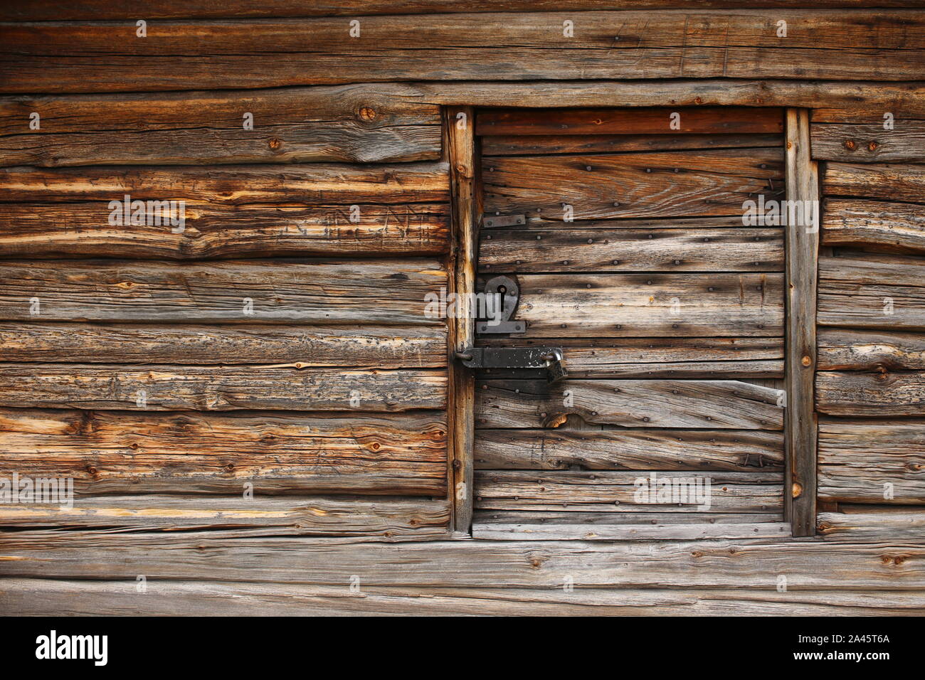 Old and rustic hatch on a log hut Stock Photo - Alamy