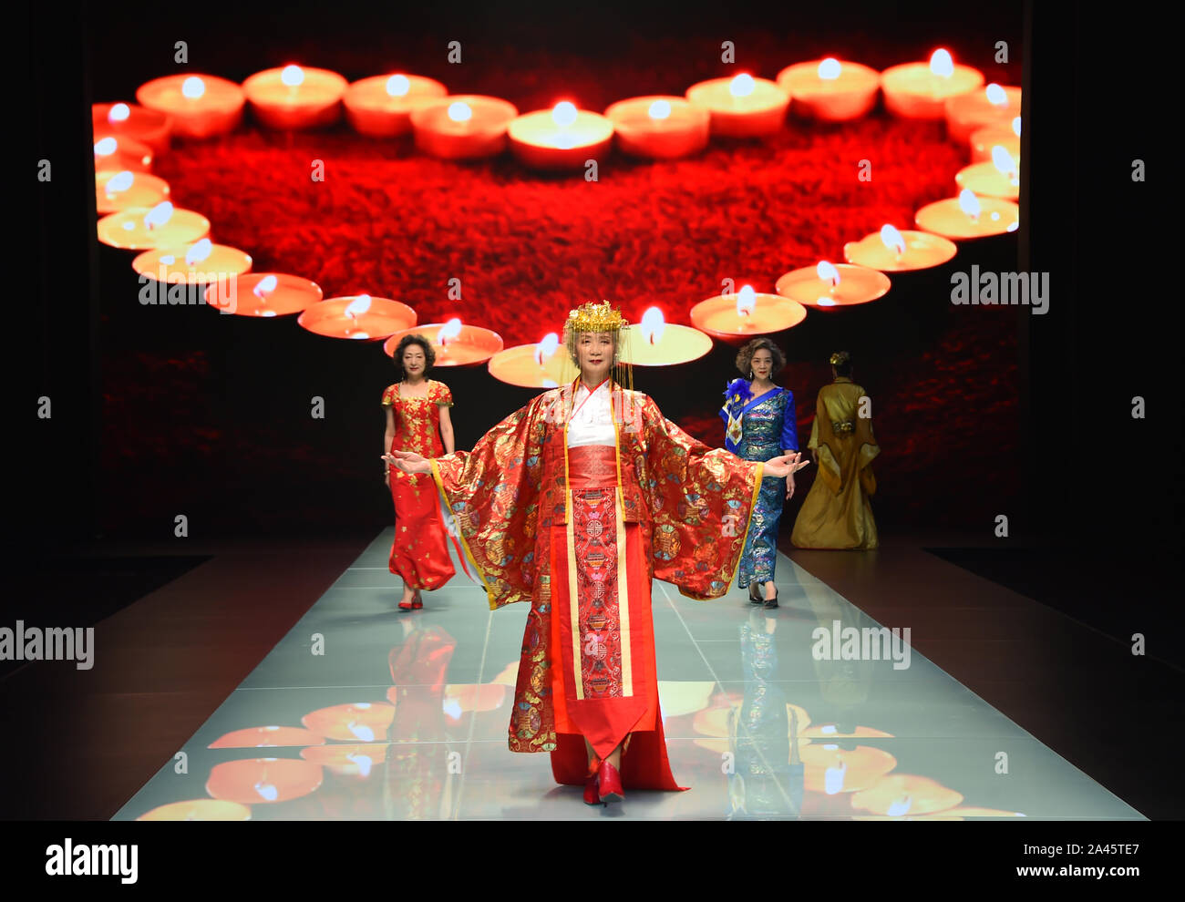 Elder models wearing traditional Chinese outfit designed by Chen Fumei ...