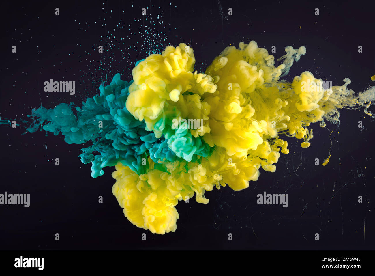 beautiful splash of yellow and green water paint on black background ...