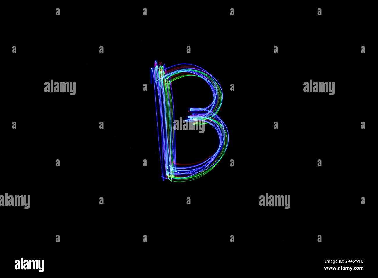 Long exposure photograph of the letter B in upper case in vibrant multi ...