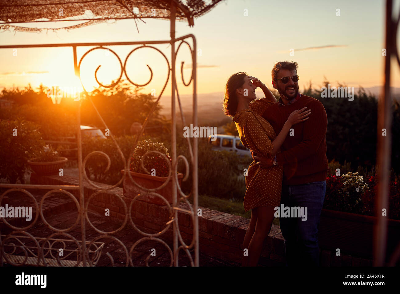 romantic couple at sunset. Young man and woman is enjoying sunset in ...