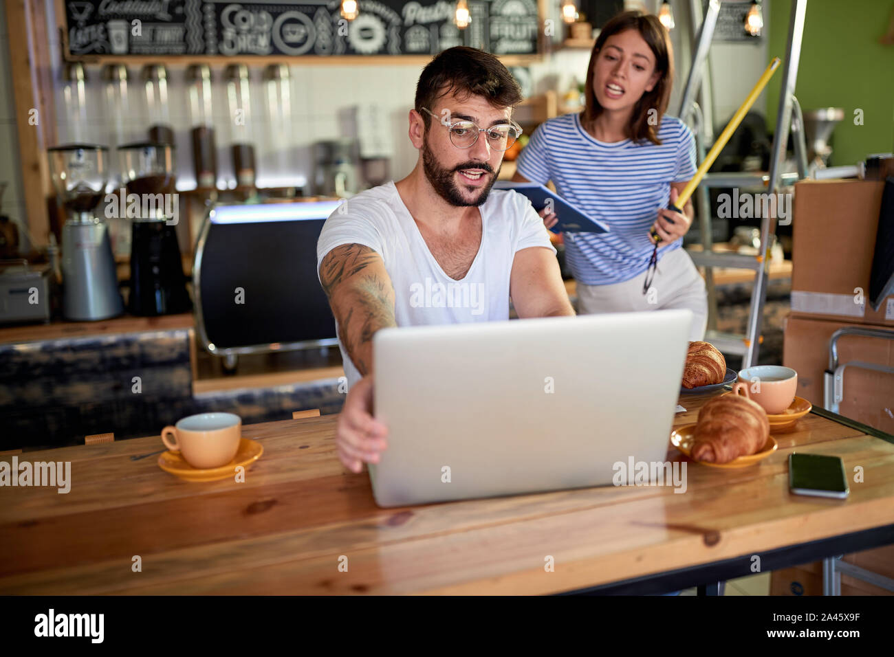 Working at coffee bar hi-res stock photography and images - Alamy