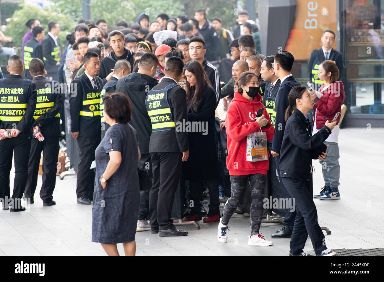 Consumers line up to buy the newly-released Adidas Yeezy, a ...