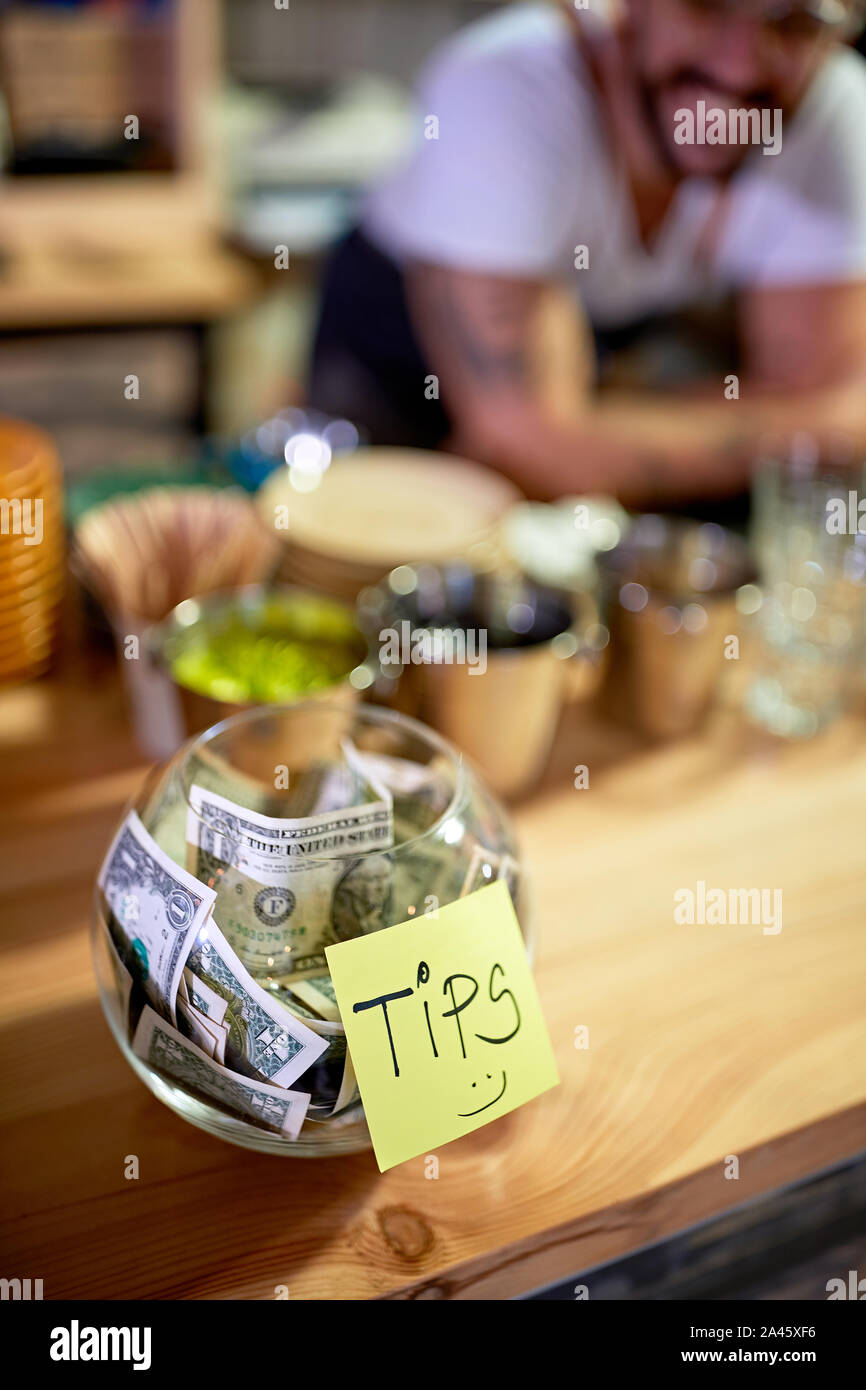 Tips - Money left for a happy employee concept Stock Photo - Alamy