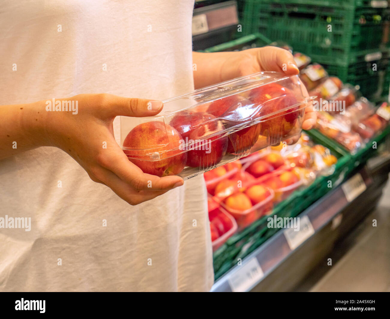 Peach in a plastic wrap Stock Photo - Alamy