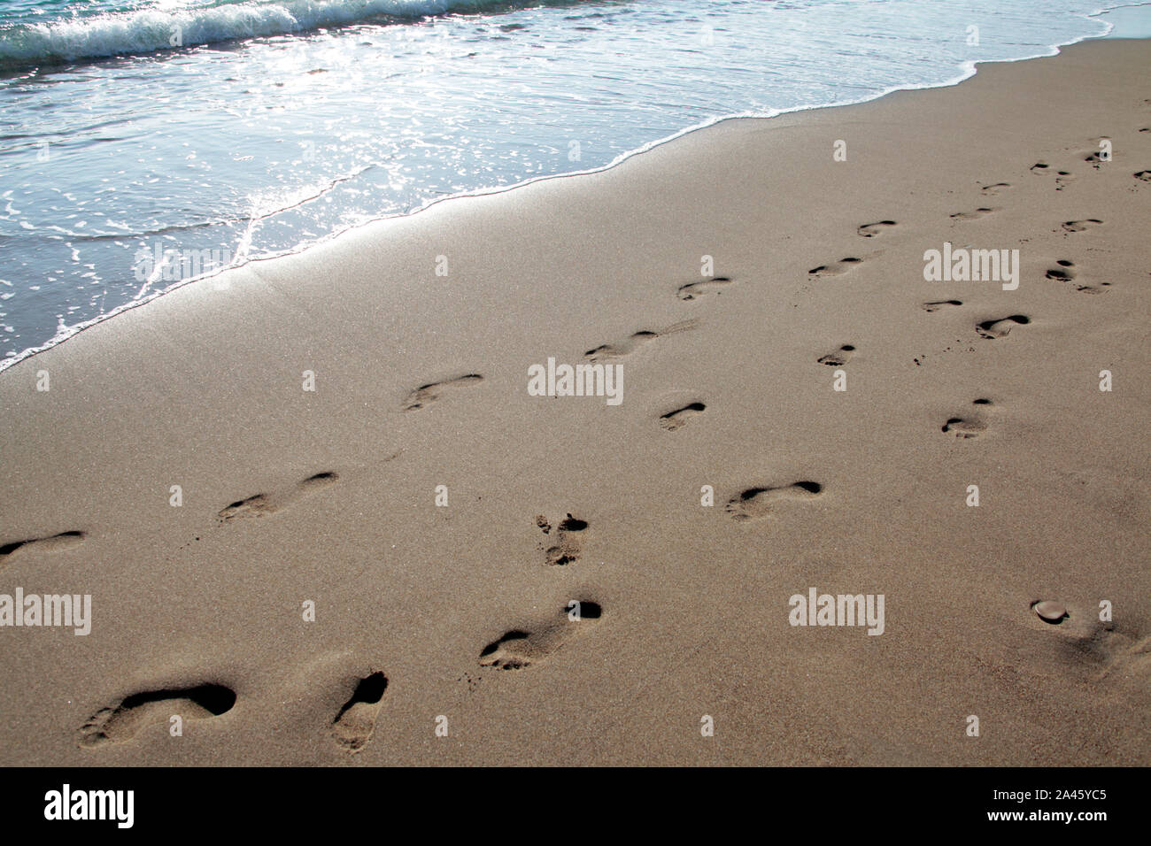 Footsteps on the sand Stock Photo - Alamy