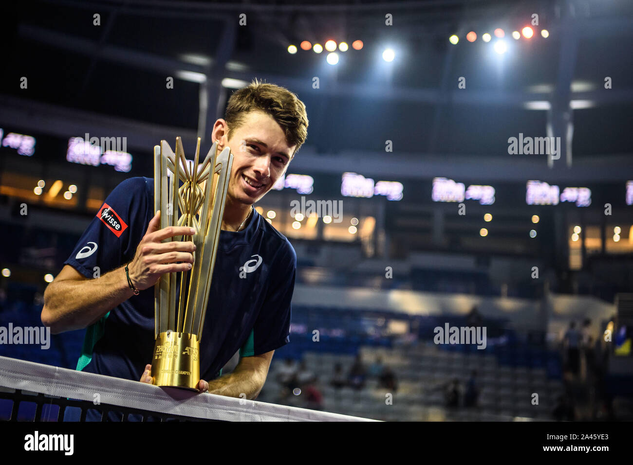 Australian professional tennis player Alex de Minaur holds the trophy of championship of Zhuhai ...