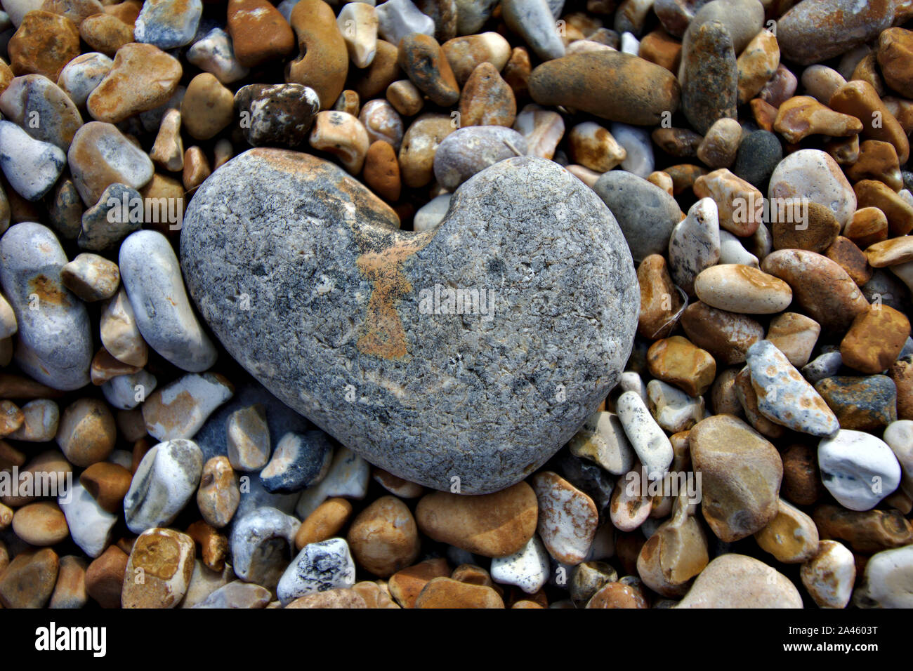 Stoned at a pebble beach in heart shape Stock Photo - Alamy