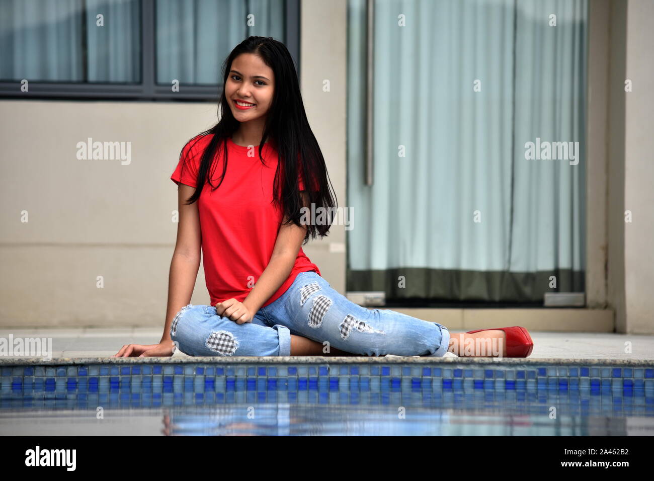 Happy Beautiful Filipina Person Sitting By Pool Stock Photo - Alamy