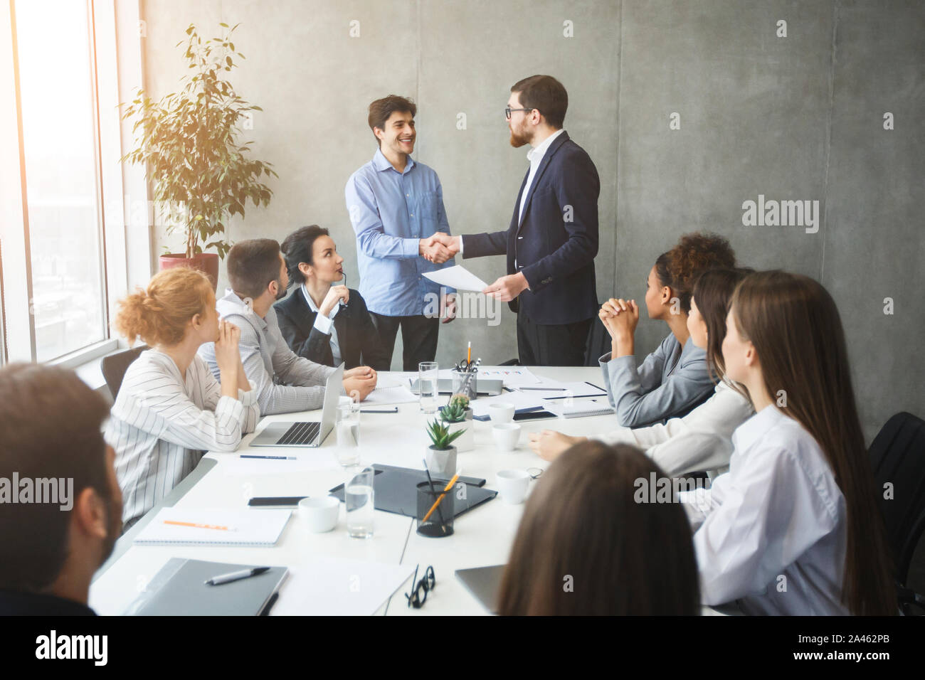 CEO congratulating successful worker by shaking hands Stock Photo - Alamy