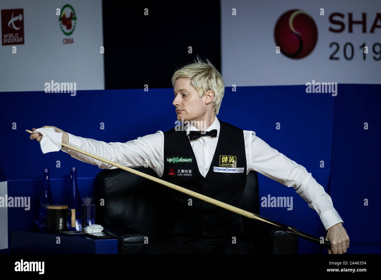 Neil Robertson of Australia wipes his cue druing the matech against ...