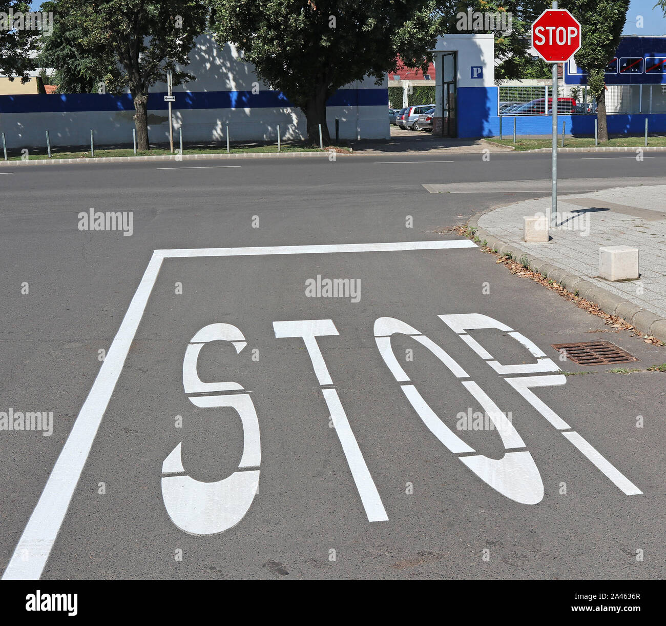 Stop sign and pole in the road crossing Stock Photo - Alamy