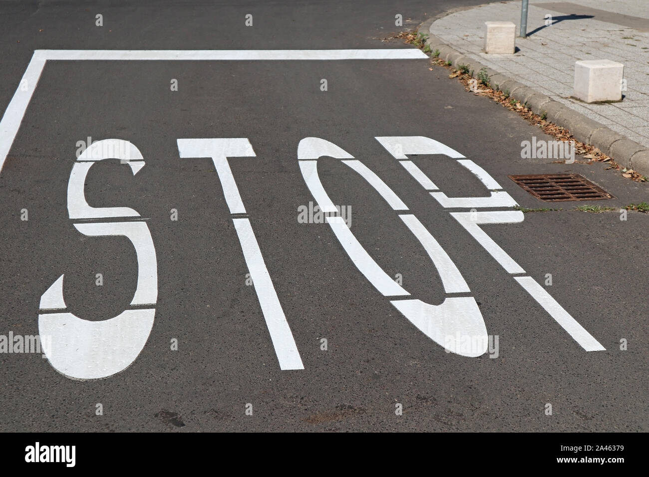 Stop sign in the road crossing Stock Photo - Alamy
