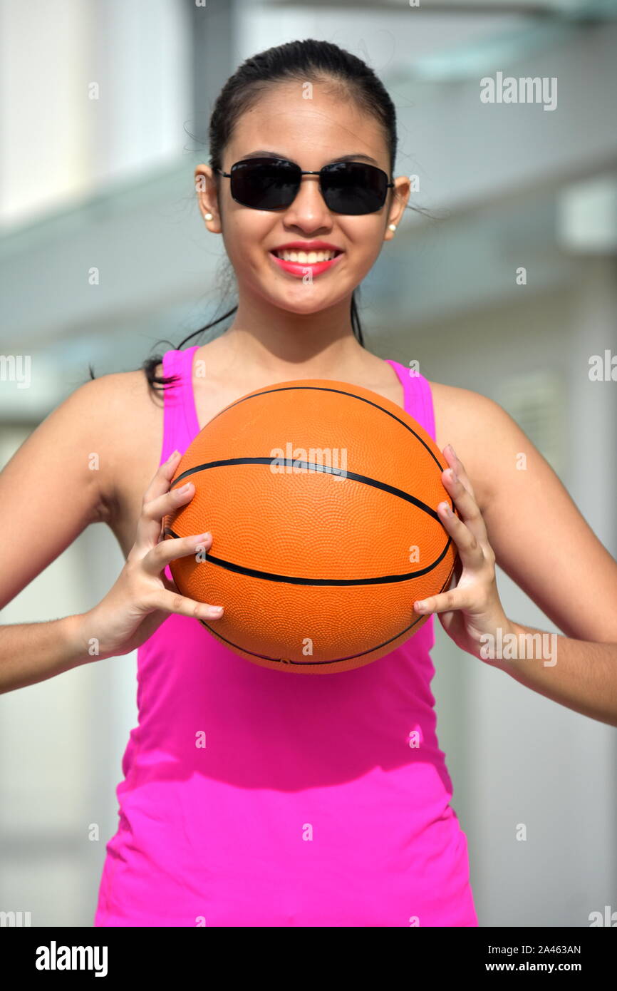 Fit Diverse Female Athlete Smiling With Basketball Stock Photo - Alamy