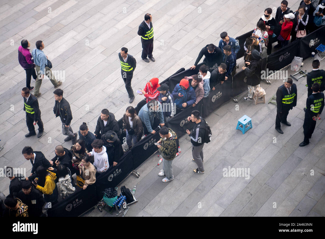 Consumers line up to buy the newly-released Adidas Yeezy, a ...