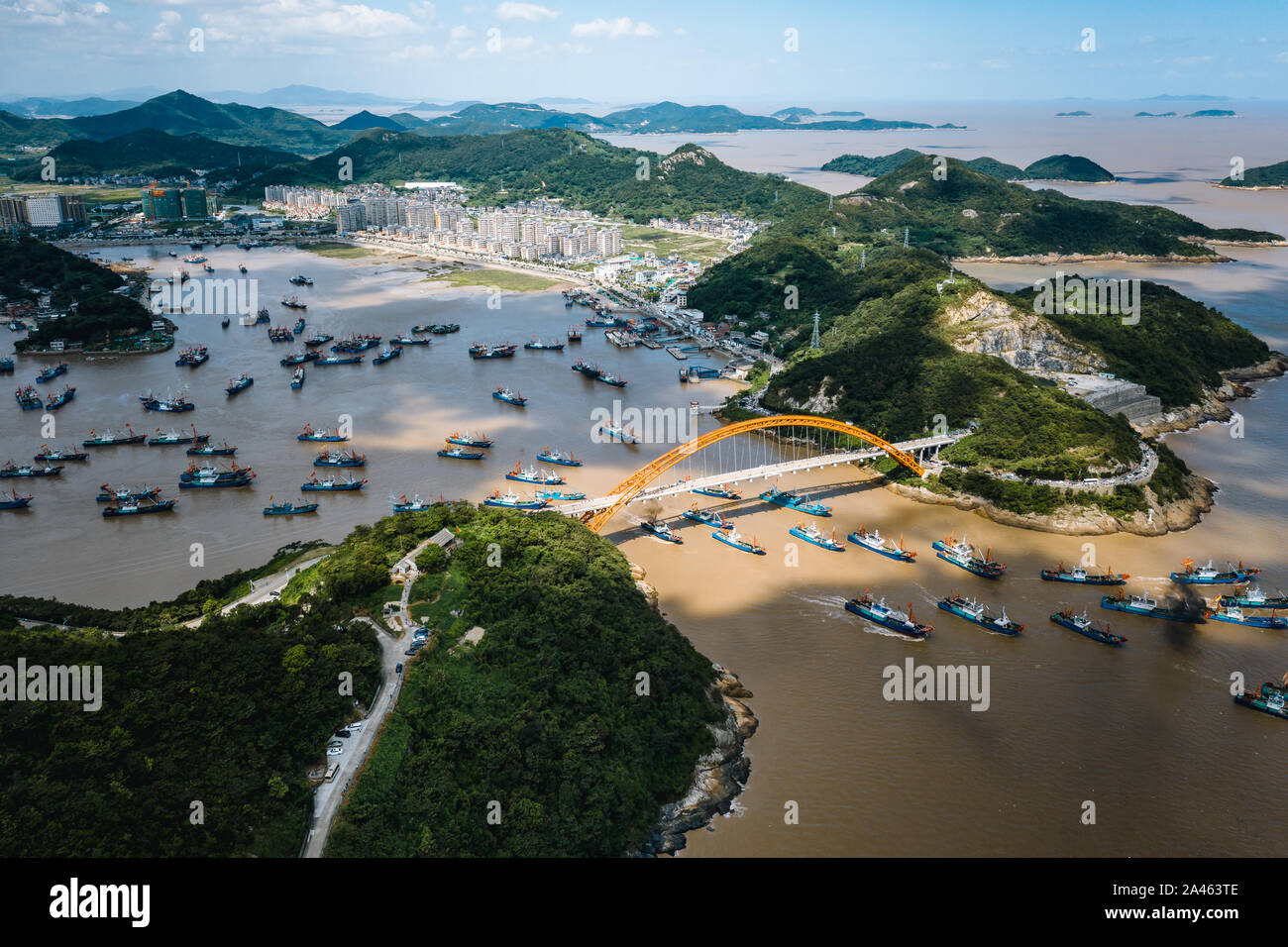 An aerial view of thousands of fishing boats heading towards the ocean ...