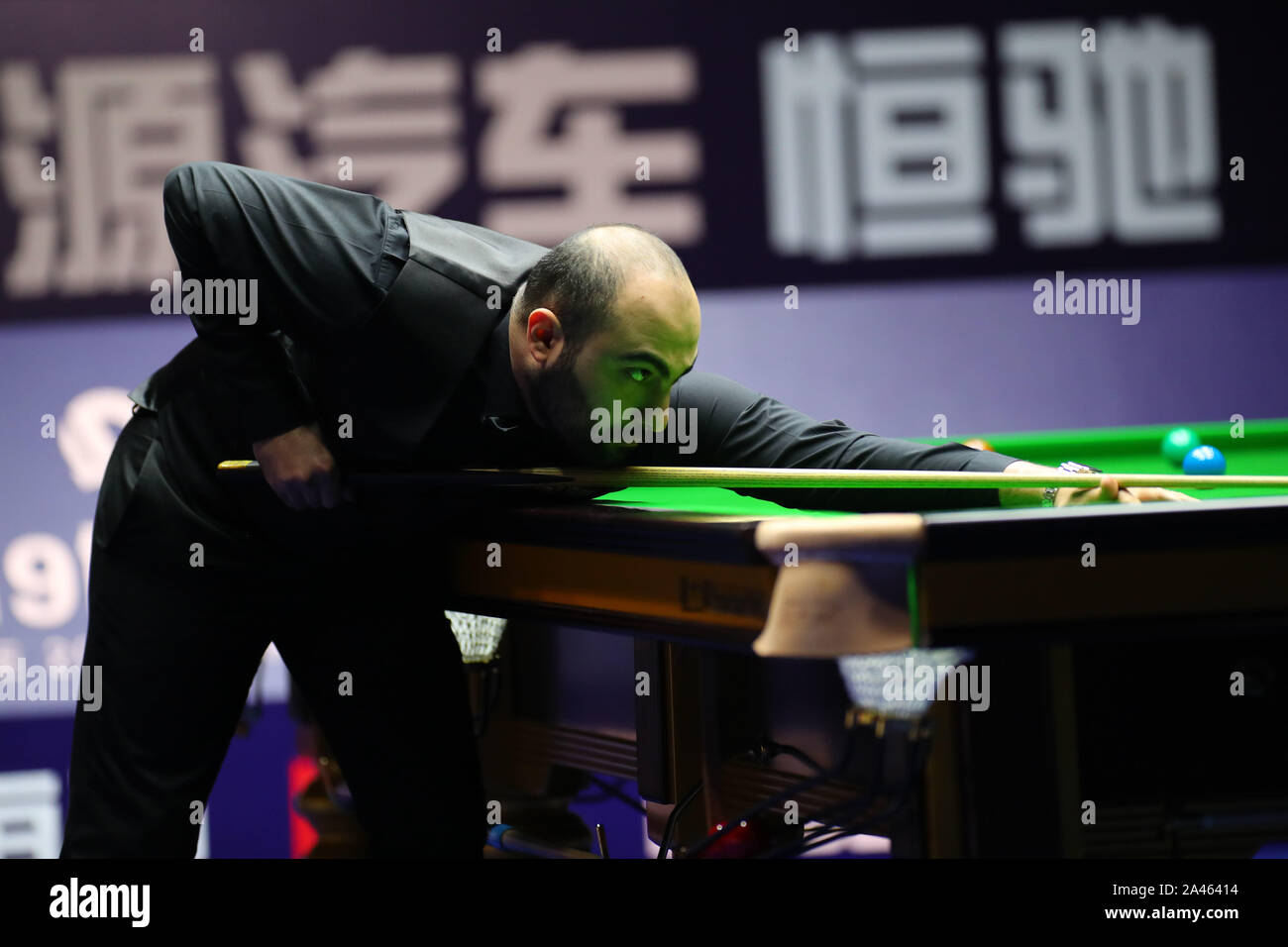 Hossein Vafaei of Iran plays a shot to Mark Williams of Wales at the ... Hossein Vafaei of Iran plays a shot to Mark Williams of Wales at the ...