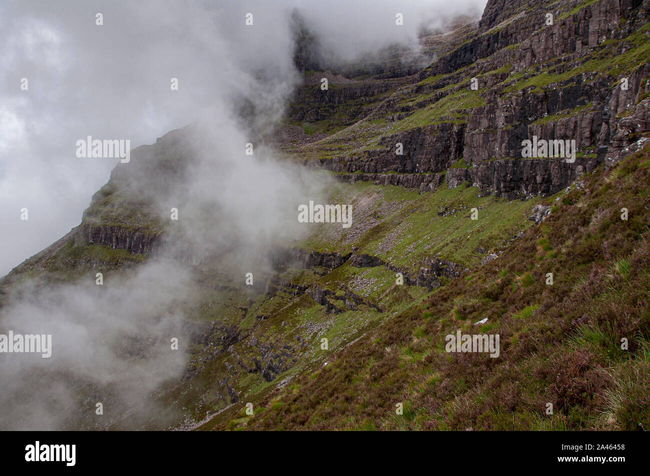 View along the ridge of Liathach, with clouds spilling over, Torridon ...