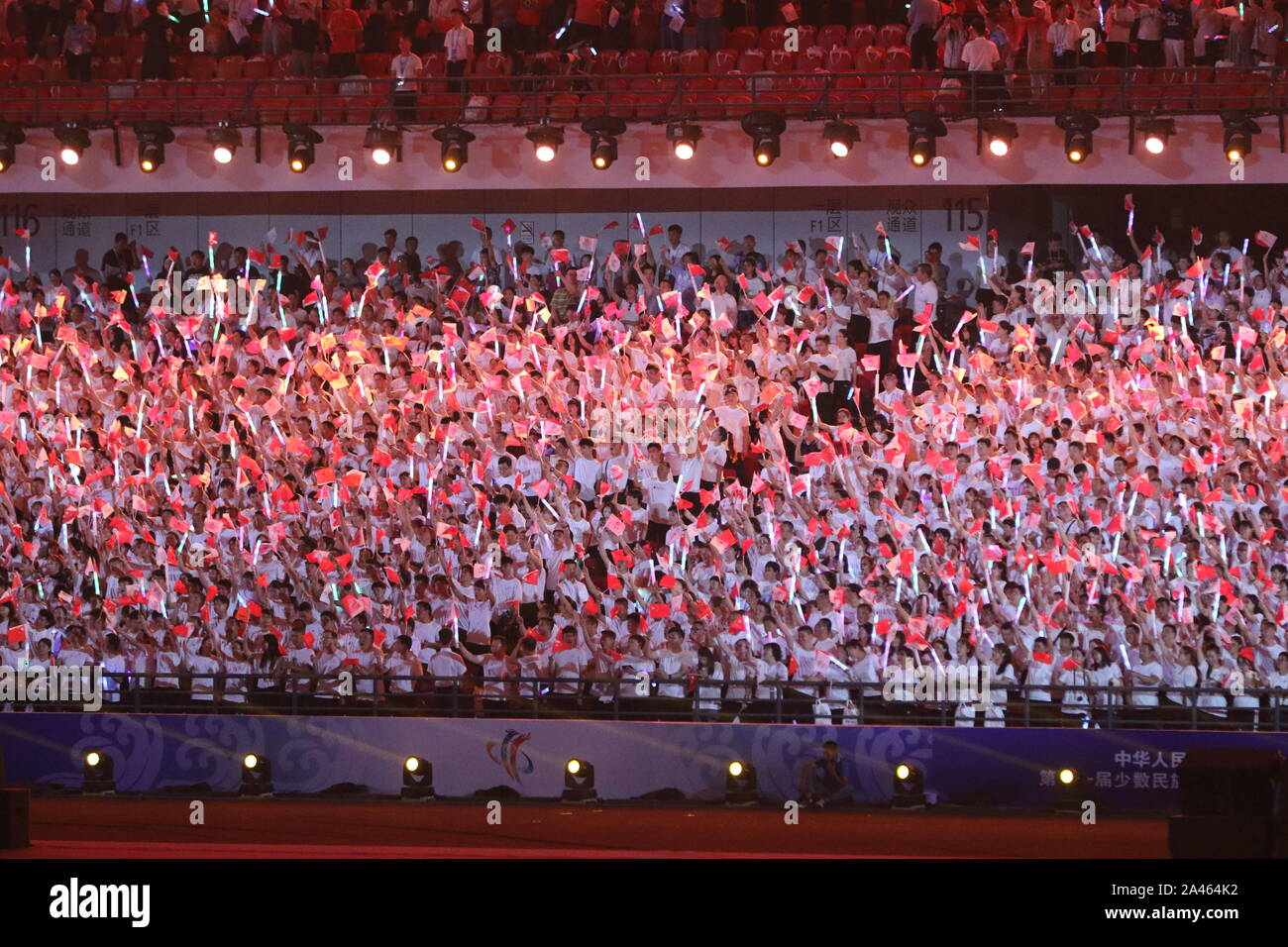 Audience wave Chinese flages at the openning ceremony of the 11th ...
