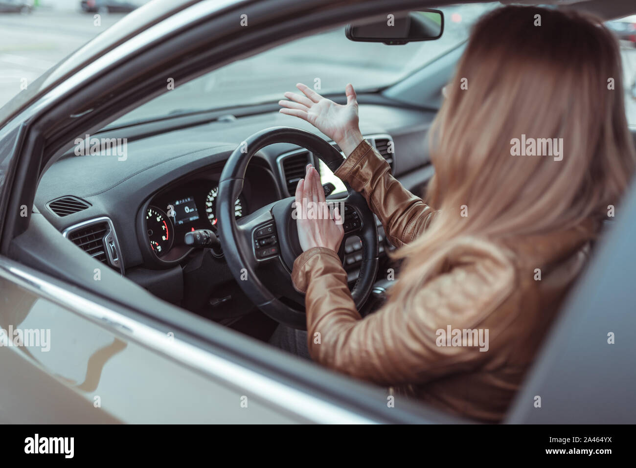woman screams aggressively, clicks signal beep steering wheel car ...