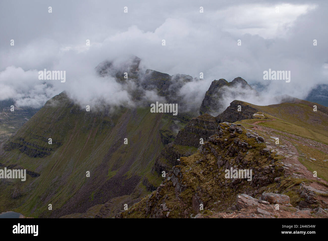 View along the ridge of Liathach, with clouds spilling over, Torridon ...