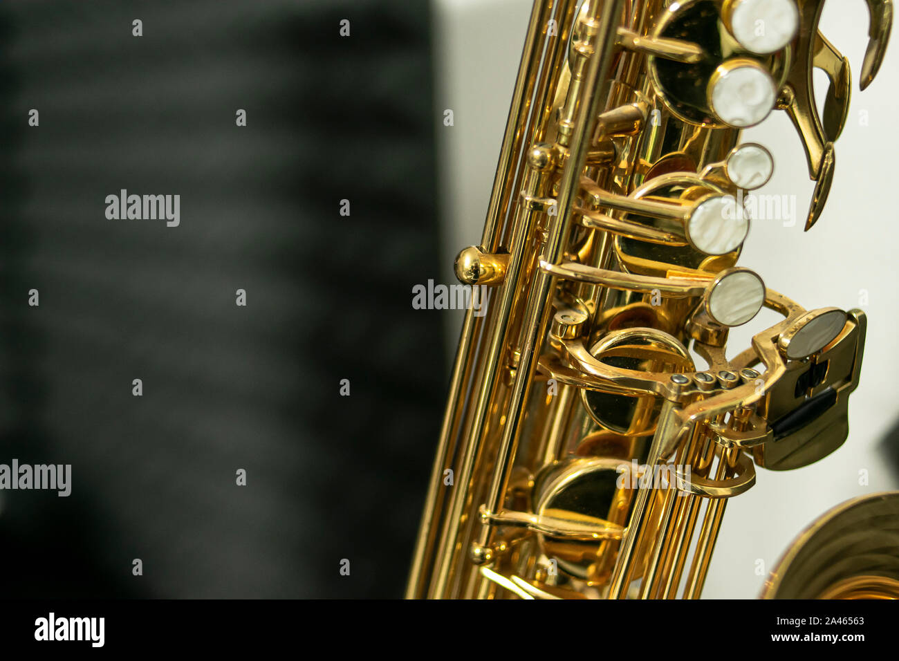 Close-up of the keys of a golden and shiny tenor sax where you can see ...