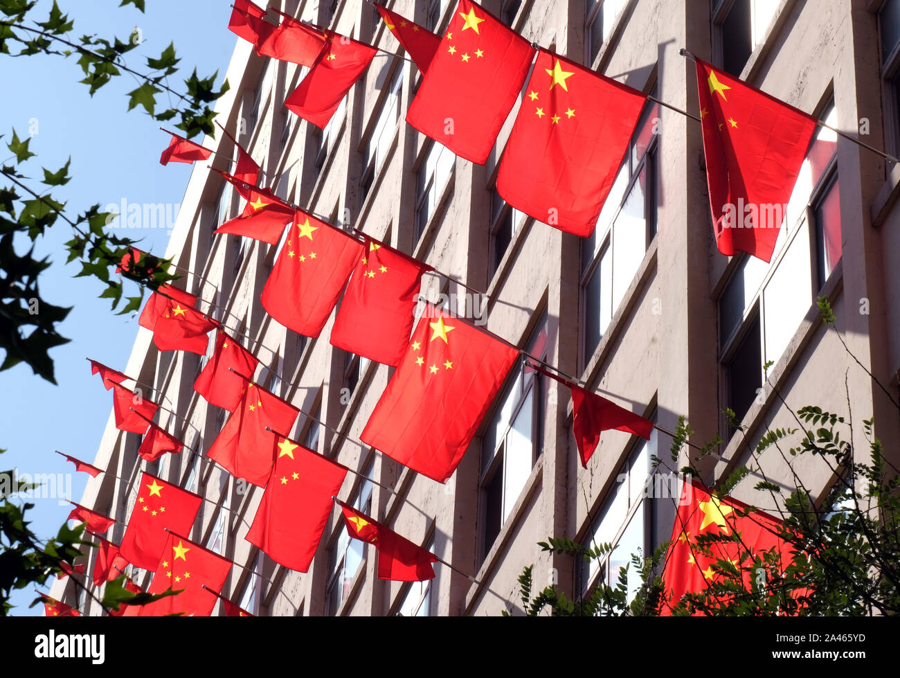 Chinese national flags flutter on the windows at the campus of Liaoning ...