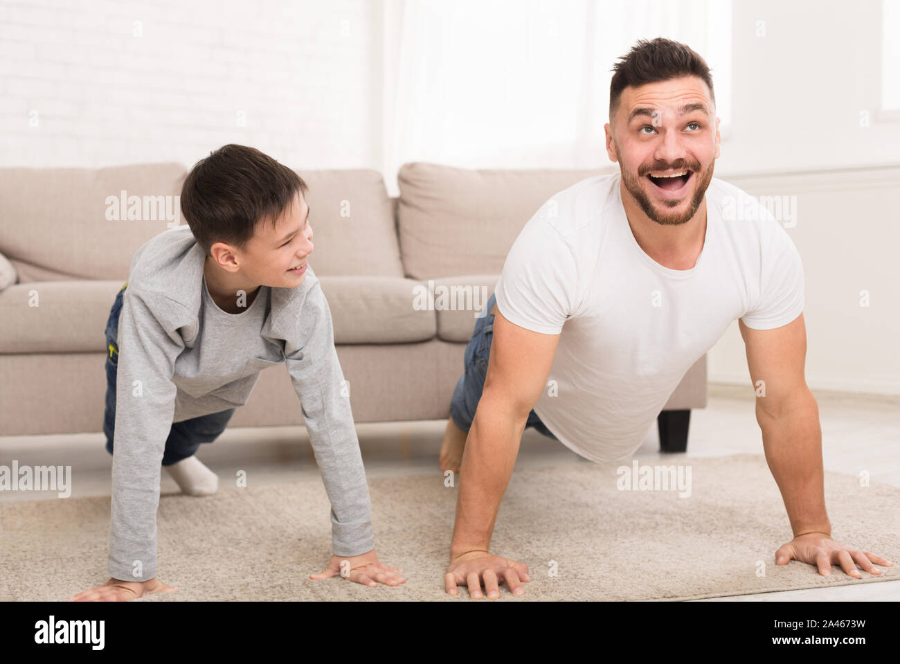 Father teaching his son doing push-ups exercises Stock Photo - Alamy