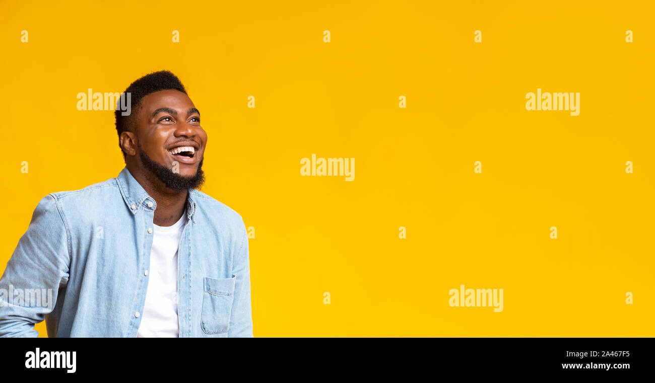 Black man looking at copy space with ecstatic face expression Stock ...