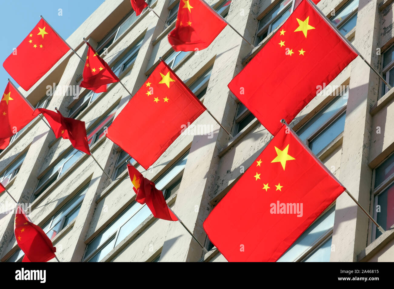 Chinese national flags flutter on the windows at the campus of Liaoning ...