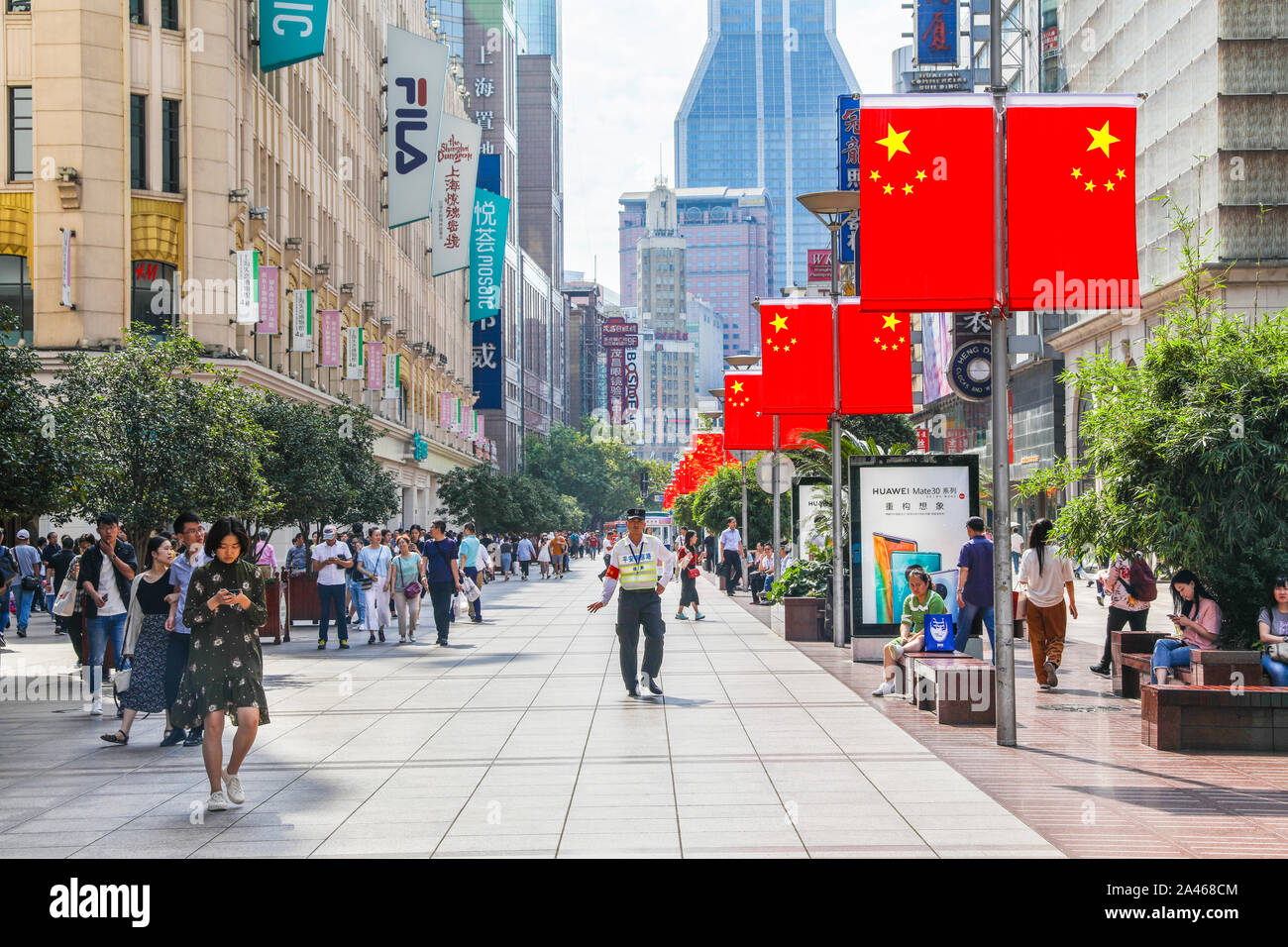 National flags fly at Nanjing Road, one of the world's busiest shopping ...